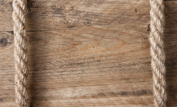 Rope frame and wood background — Stock Photo © DarkBird #32544409