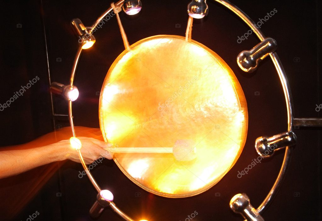 Hand striking a gong - motion-blurred hand Stock Photo by ©Elnur_ 4429161