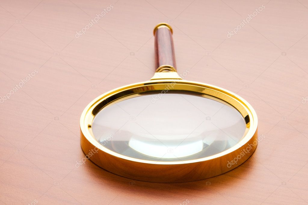 Magnifying glass with wooden handle on the flat surface Stock Photo by ...