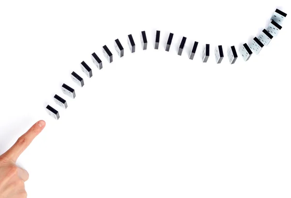 Hand ready to push domino pieces to cause chain reaction — Stock Photo ...
