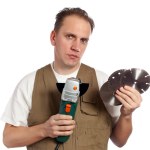 The man, the builder, chooses a detachable disk for the tool Stock ...