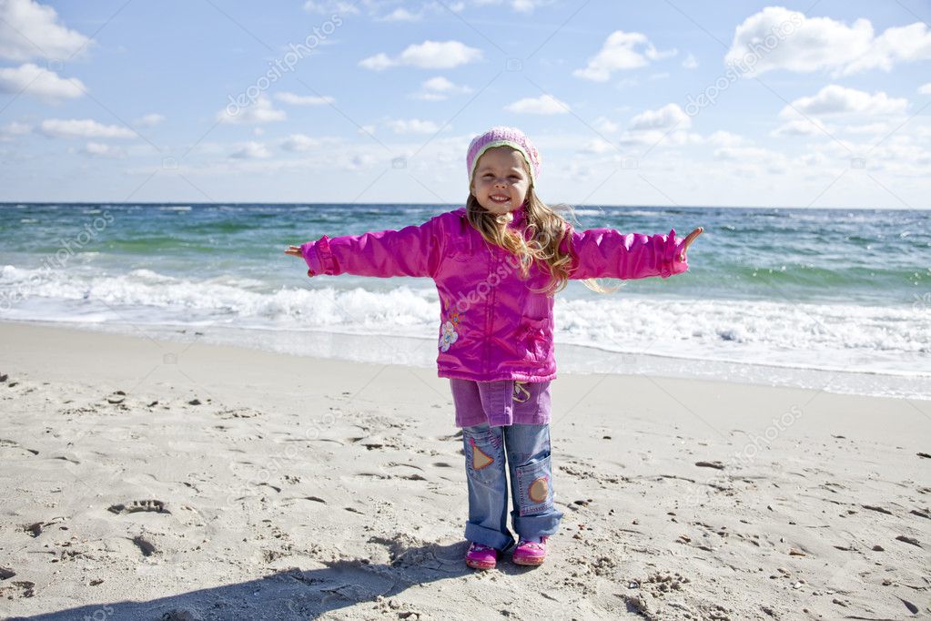 Cute young girl having fun on the beach Stock Photo by ©massonforstock ...