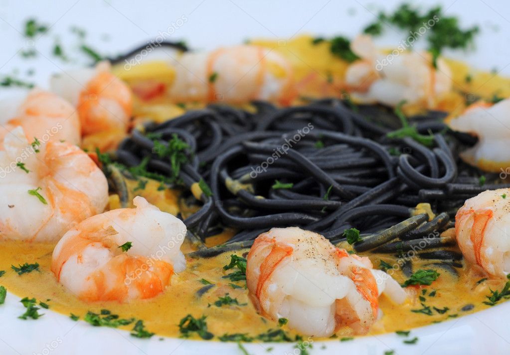 Scampi with inkfish pasta and curry sauce Stock Photo by ©annavee 4662003