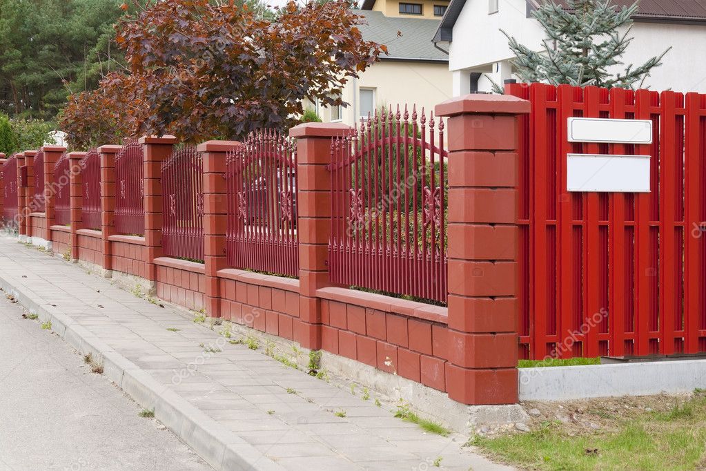 The red fence is located in rural street Stock Photo by ©vilaxlt 4269265