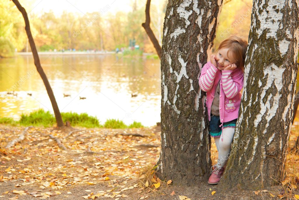 Smiling girl stands between birch trees — Stock Photo © zakazpc #3924422