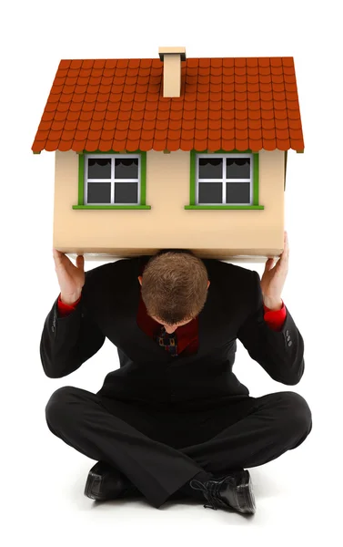Business man holding house on his back — Stock Photo © erierika #4270906