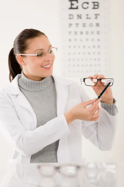 Optician doctor woman with glasses and eye chart - Stock Image - Everypixel